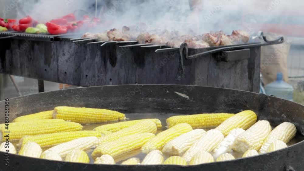 Corn in hot water as street food at a street food fair or festival ...