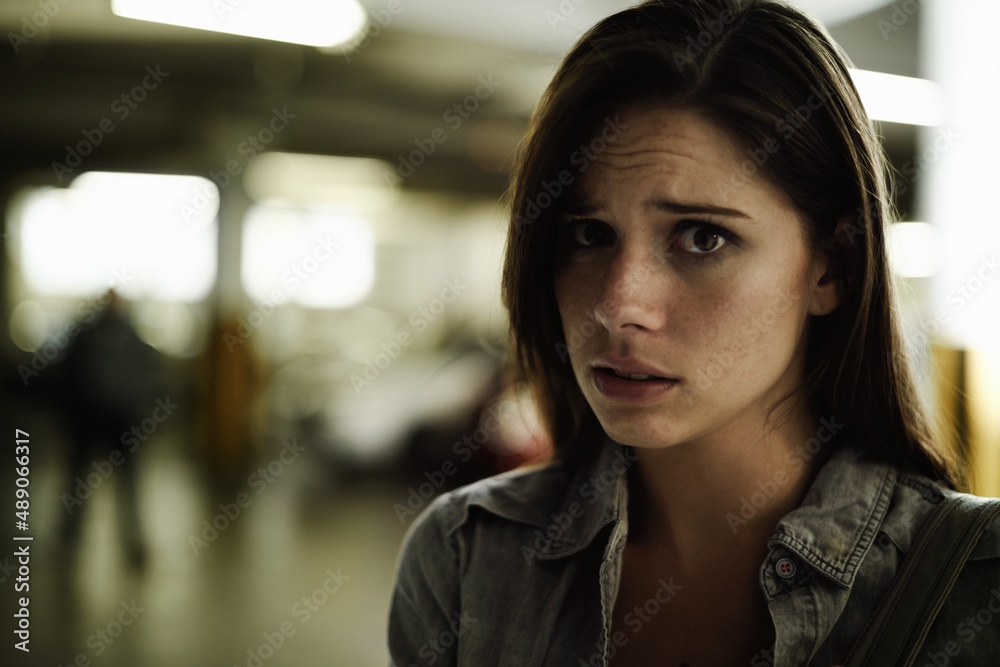 Feeling a twinge of fear. A terrified young woman in an underground ...