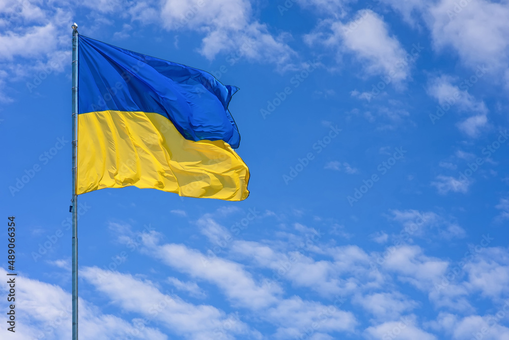 Ukraine flag isolated on the blue sky. Close up waving flag of Ukraine ...