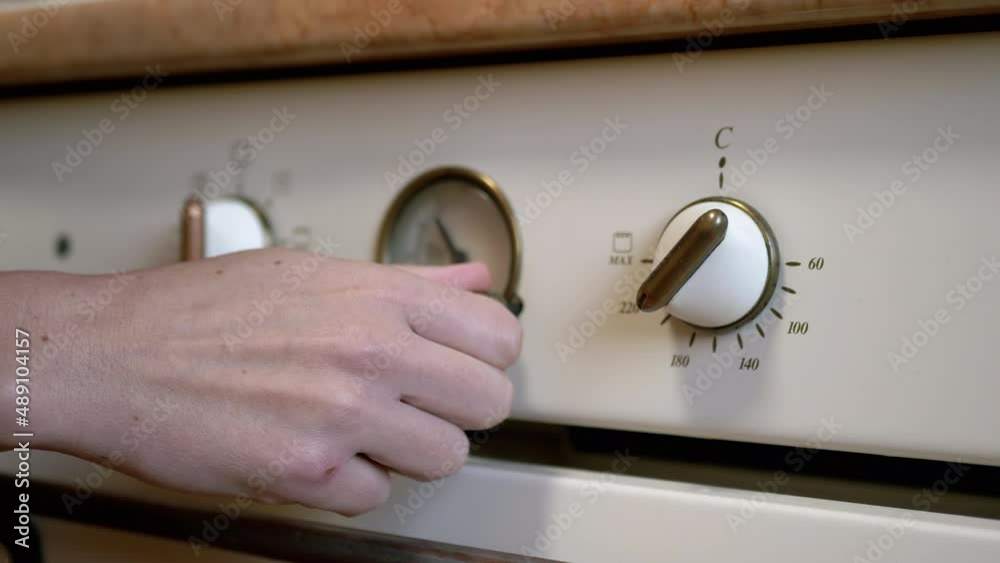 A Female Hand Sets the Time, Mode, Cooking Temperature on a Modern Oven ...