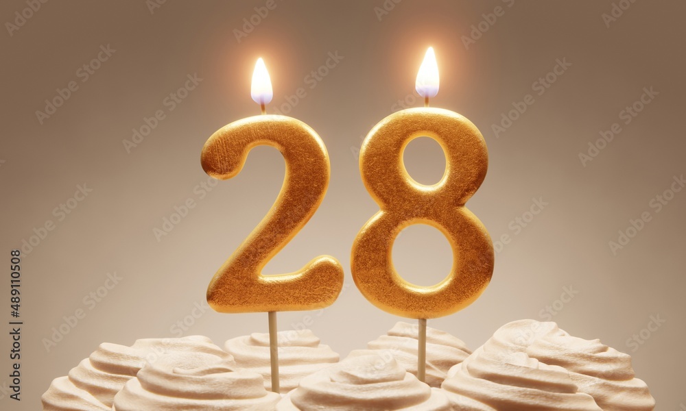 28th birthday or anniversary celebration. Lit golden number candles on ...