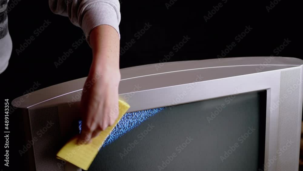 Female Hand Wipes Dust with a Yellow Rag from Surface of an Old TV in ...