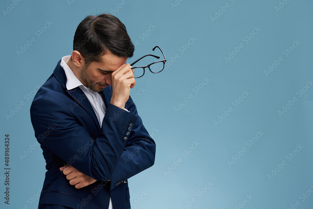 businessman with a tired look with glasses blue suit hand gestures ...