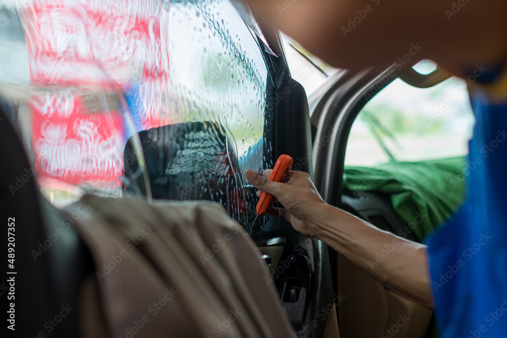 Technician Installing car window tint. Car window tinting series. Car ...