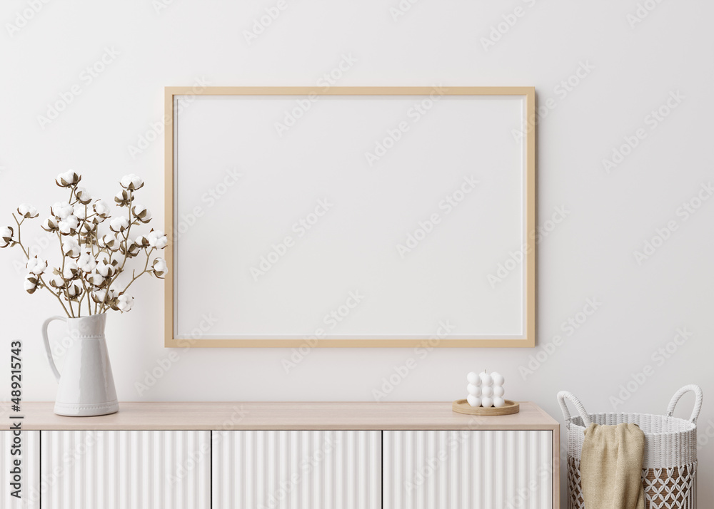 Empty horizontal picture frame on white wall in modern living room ...