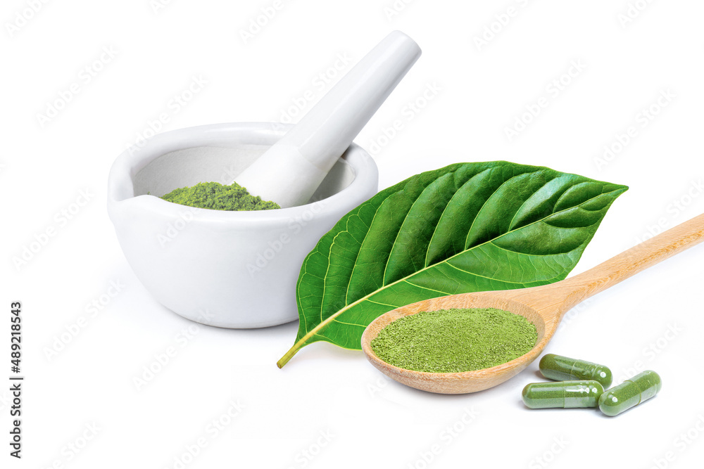 Kratom leaf (Mitragyna speciosa) with powder capsules isolated on white ...