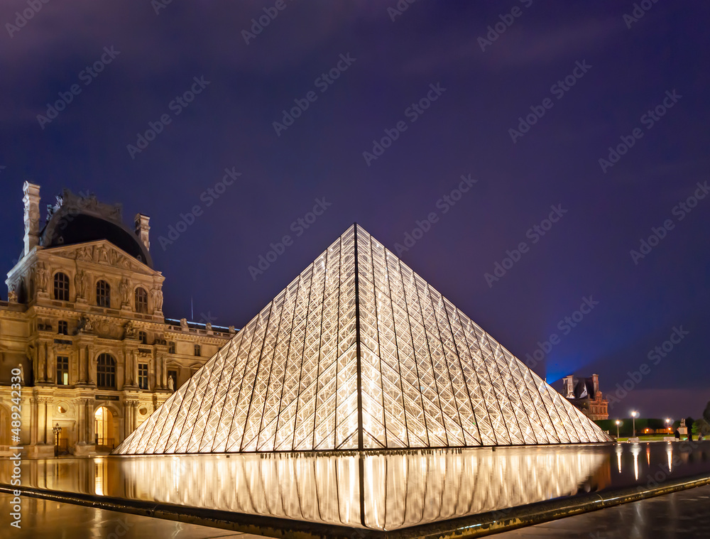 Close up of Louvre Pyramid (by night), Paris, France. The Louvre is the ...