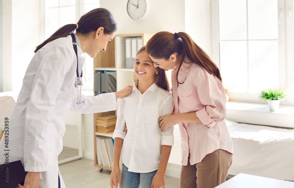 Mom and her teen daughter during regular checkup at modern hospital ...