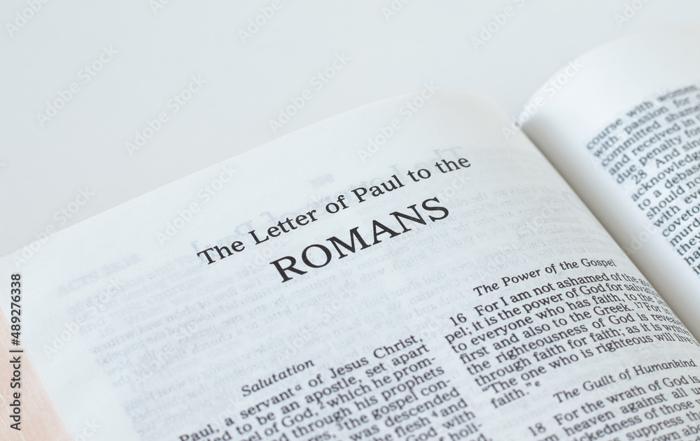 Romans open Holy Bible Book isolated on white background. A close-up ...