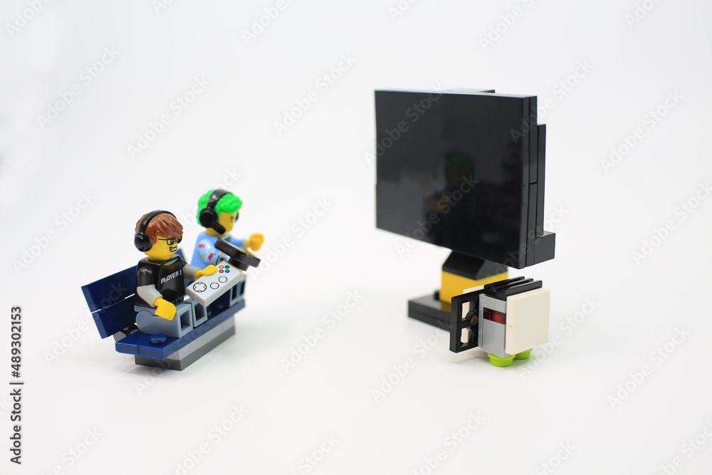 Hong Kong - February 26 2022: minifigure act as two young gamer playing ...