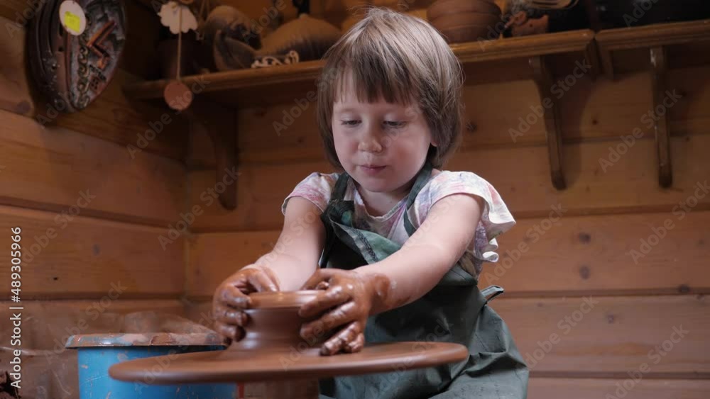 Making pottery clay kids. Close up hands pottery wheel clay potter ...