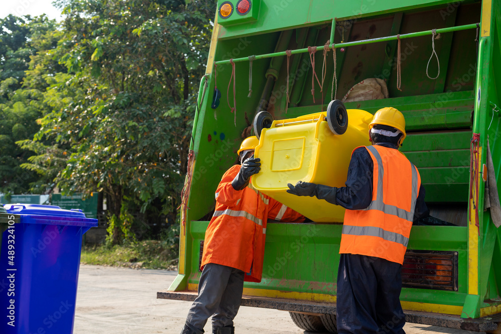 Garbage collector, Two garbage men working together on emptying ...