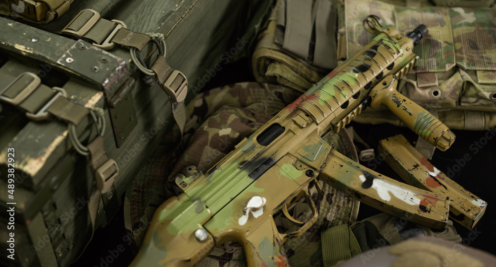 mp5 automatic rifle next to ammunition box and other military ...