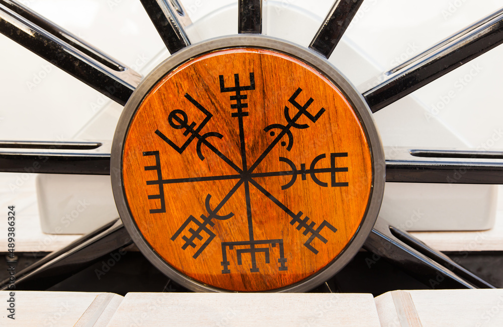 Unusual scandinavian symbols and signs on the helm of a sailing yacht ...