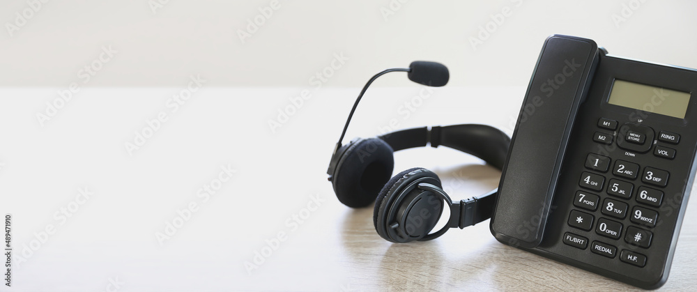 Customer service concept. Close-up headphone and telephone for ...
