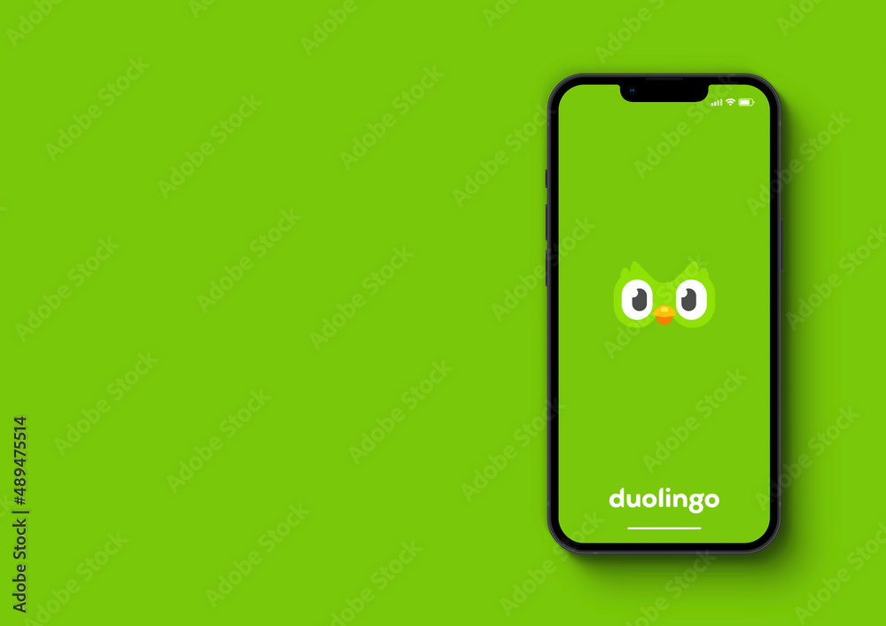 Duolingo app on the smartphone iPhone 13 screen. Green background. Rio ...