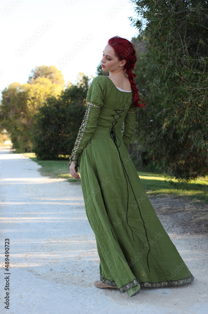 Full length portrait of red haired woman wearing a beautiful green ...