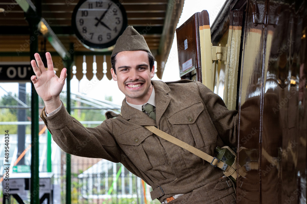 Handsome male British soldier in WW2 vintage uniform at train station ...