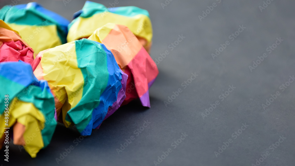 Rainbow colored paper wrinkled cubes on black and blur background ...