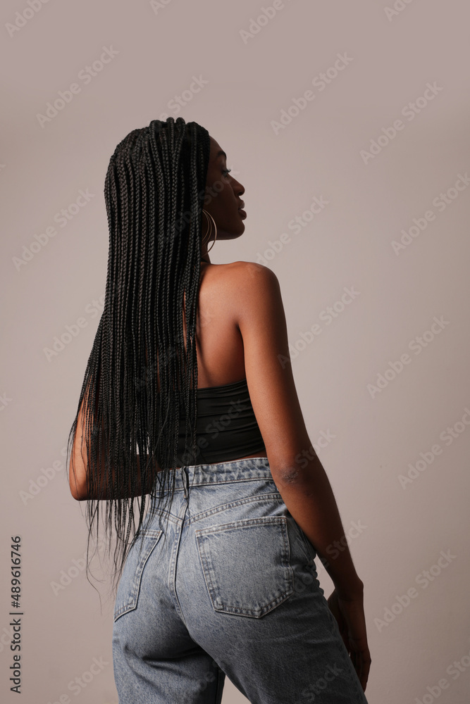 Back view of young afro American woman with long braids posing over ...