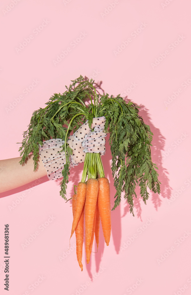 Spring creative layout with hand in lace glow holding bright orange ...