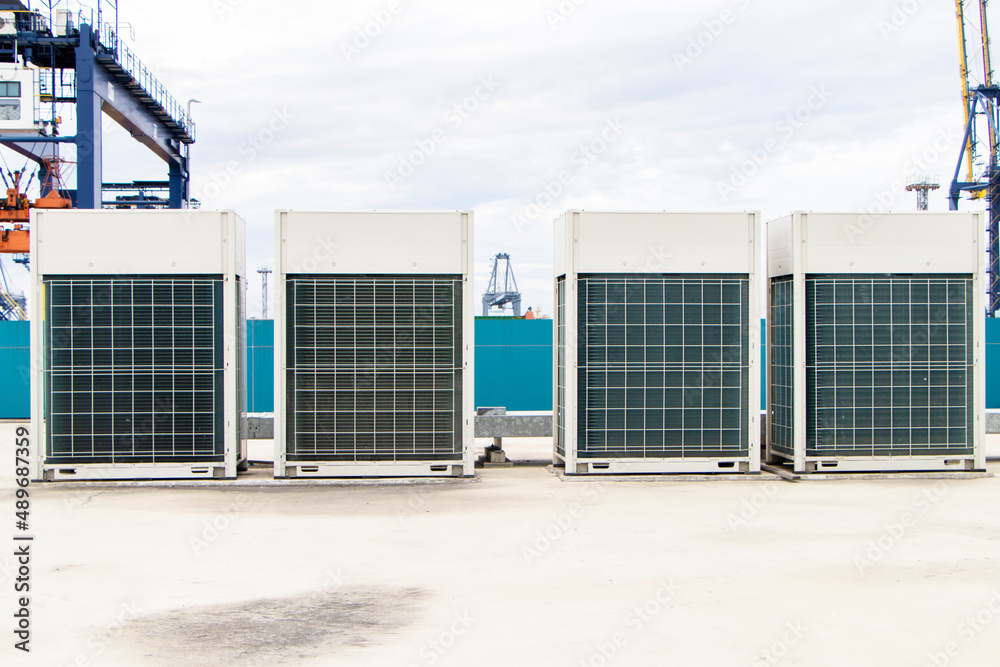 Big air conditioner compressor source heat pumps. On wall outdoor on ...