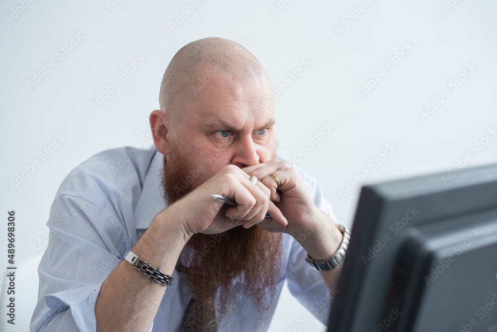 Problems for the office worker. A bald man in a white shirt sits at a ...