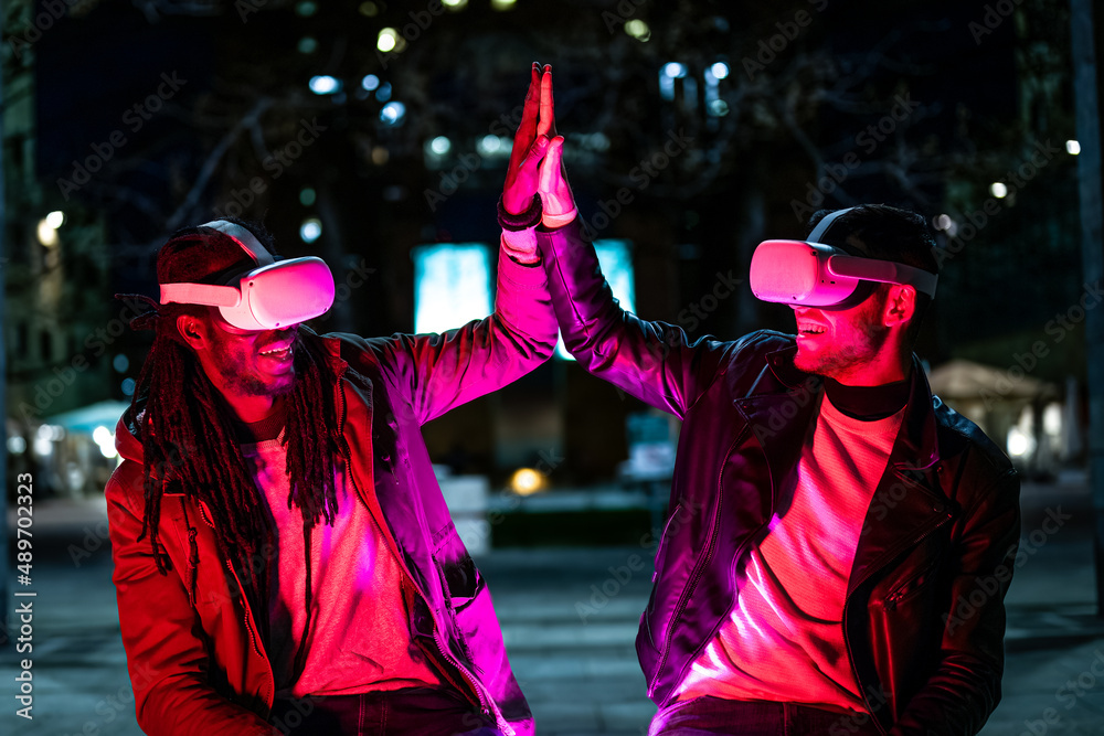 Young multiracial friends playing in virtual reality and win, people ...