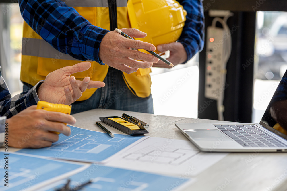 Two people are discussing the design of the building plan, the ...
