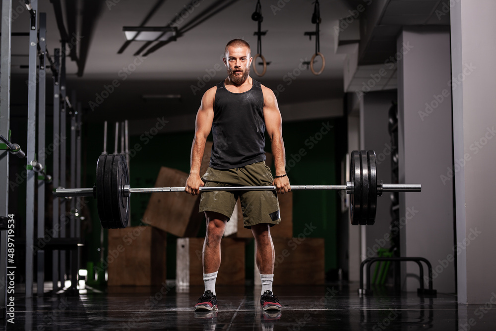 Muscular athlete lifting very heavy barbell Stock Photo | Adobe Stock