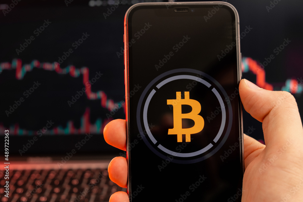 Bitcoin SV BSV cryptocurrency logo on the screen of smartphone in mans ...