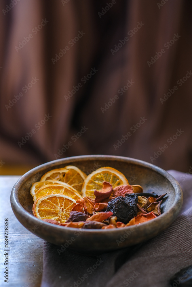 Dried fruits in an old clay plate on a wooden table. Compote. Uzvar ...