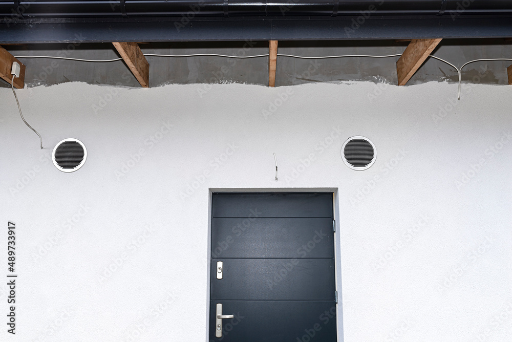 Air intake and exhaust in the wall of a single family house for ...