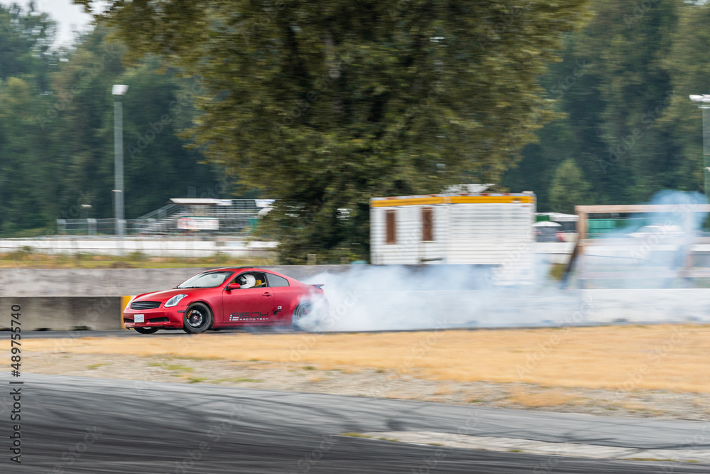 Red Drift Car / Race car drifting around corner very fast with lots of ...