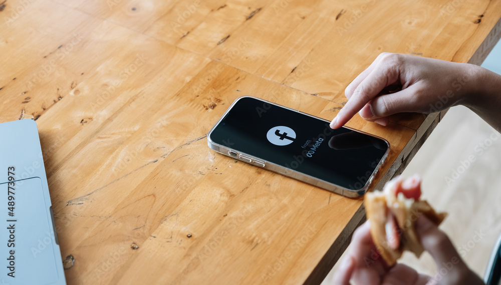 CHIANG MAI. THAILAND. FEB 26, 2022. A woman holds Apple iPhone 13 with ...