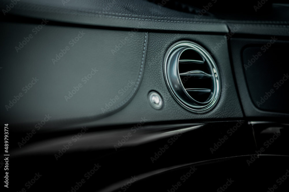 Passenger side ventilation in a modern car. Visible round orifice for ...