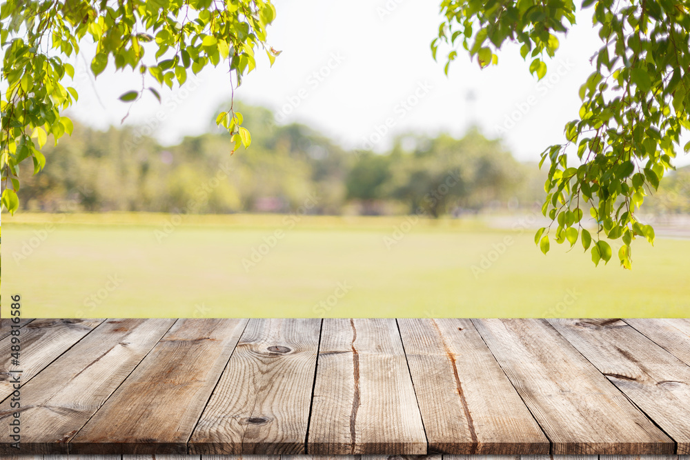 Empty wooden table with garden bokeh for a catering or food background ...