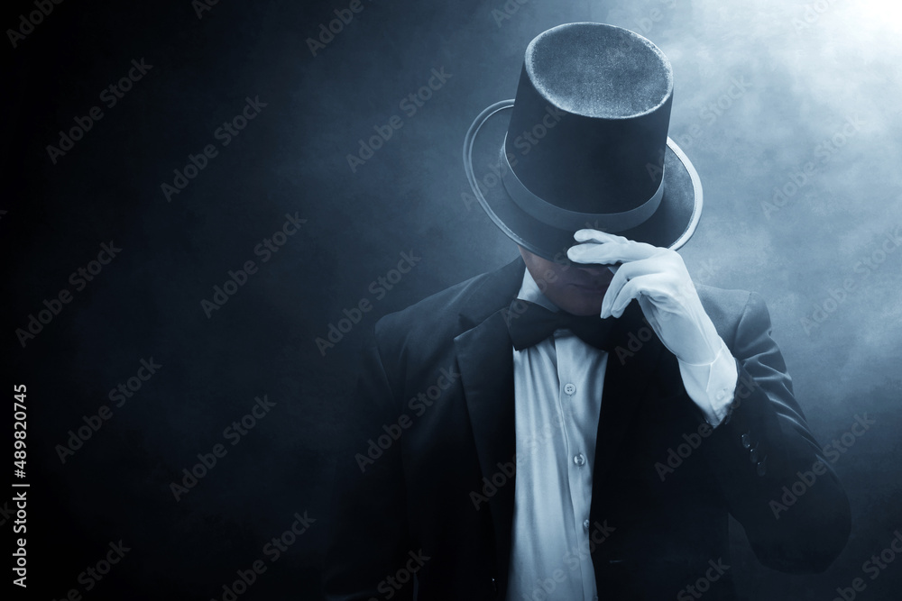 Mysterious man in black suit on dark background Stock Photo | Adobe Stock