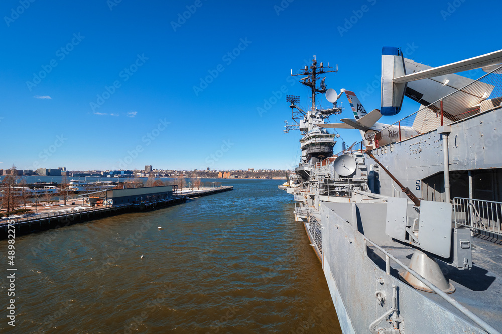 View of the island, cannon and airplanes parked on the flight deck of ...