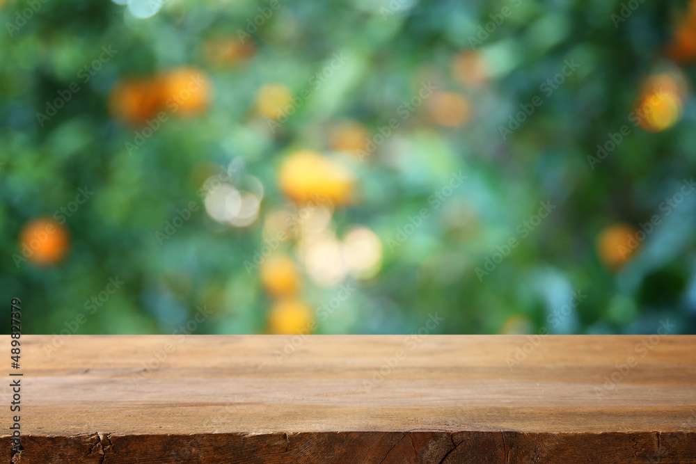Empty wooden table in front of orange field Stock Photo | Adobe Stock
