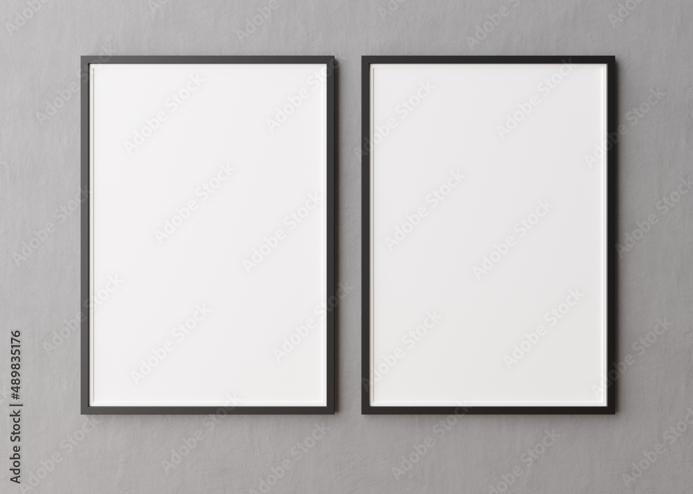 Two blank vertical picture frames hanging on concrete wall. Template ...