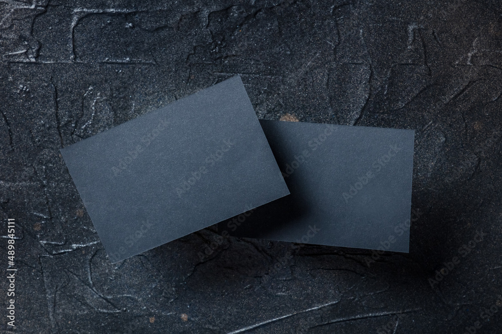 Black business card mockup, front and back, on a dark background, a ...