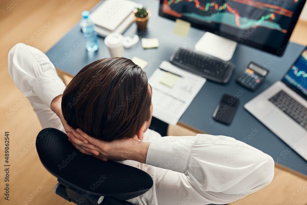 Businessman trading stocks online. Stock investor analysing numbers at ...