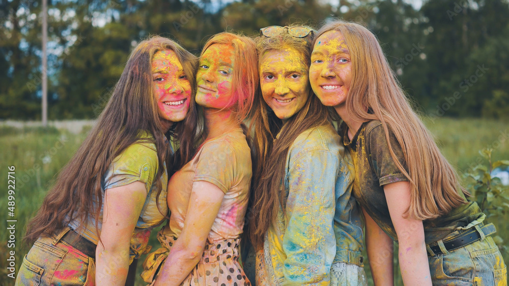 Cheerful girls posing smeared in multi-colored powder. Stock Photo ...