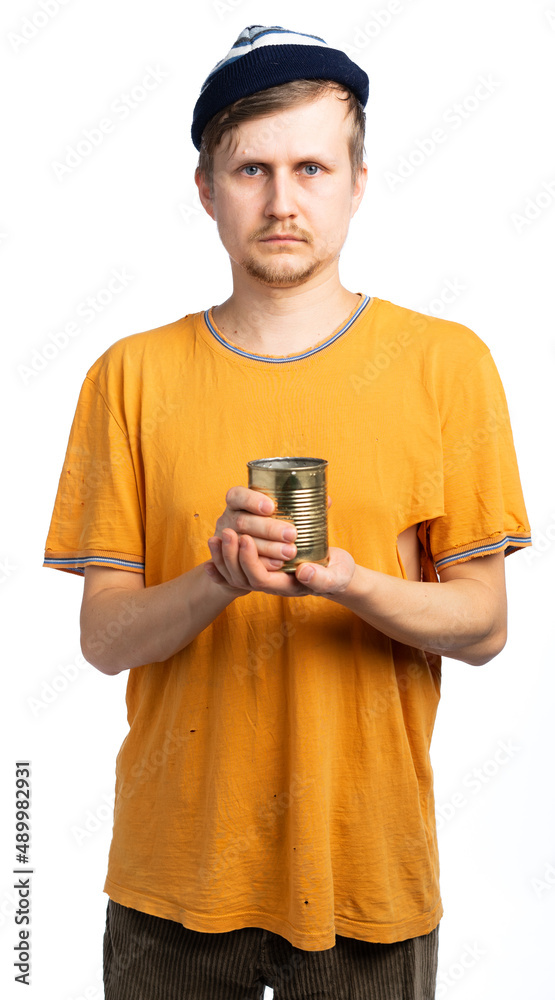 a man in torn old clothes holds an empty tin can in front of him and ...