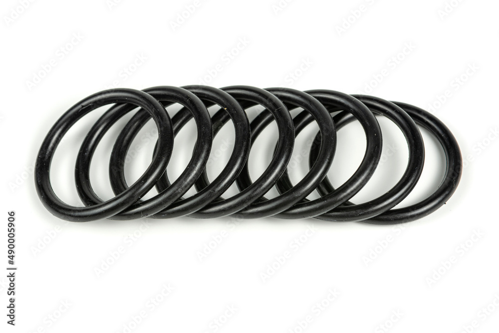 Hydraulic and pneumatic o-rings in black in different sizes on a white ...