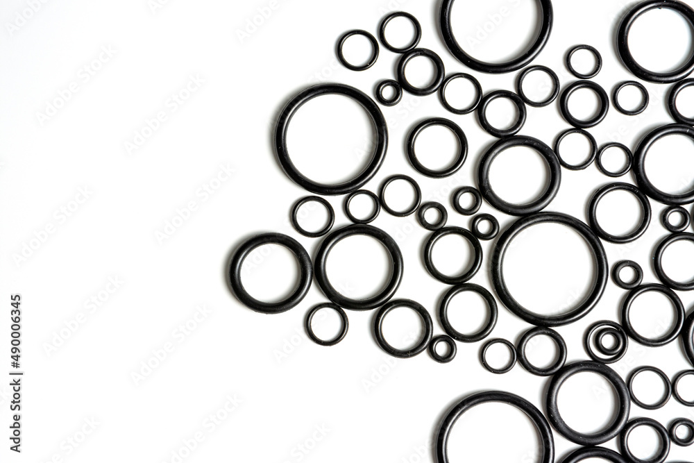 Hydraulic and pneumatic o-rings in black in different sizes on a white ...