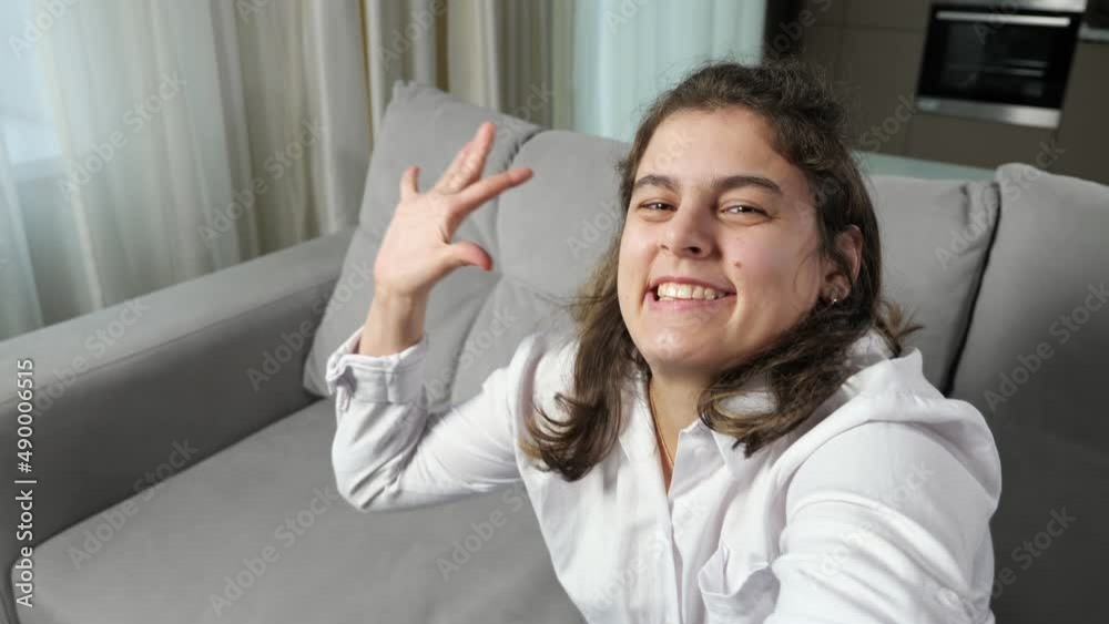 Disabled woman with cerebral palsy makes fingers Victory sign and ...