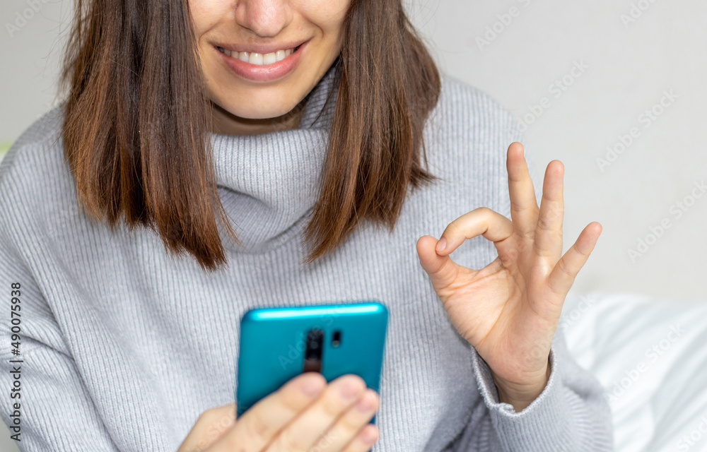 cute girl is speaking on the mobile phone with her friends or family ...