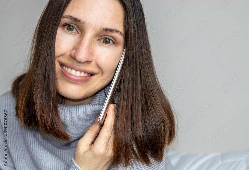 cute girl, woman is speaking on the mobile phone with her friends or ...